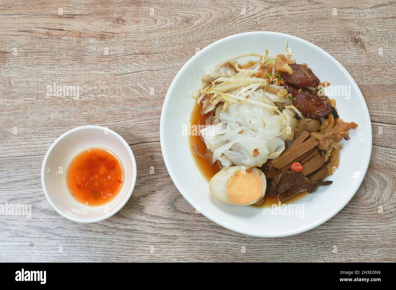 steamed large rice noodles topping slice fried Chinese sausage and pork ...