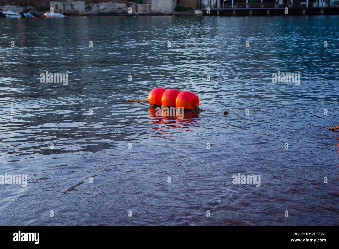Red buoys in a small bay Stock Photo - Alamy