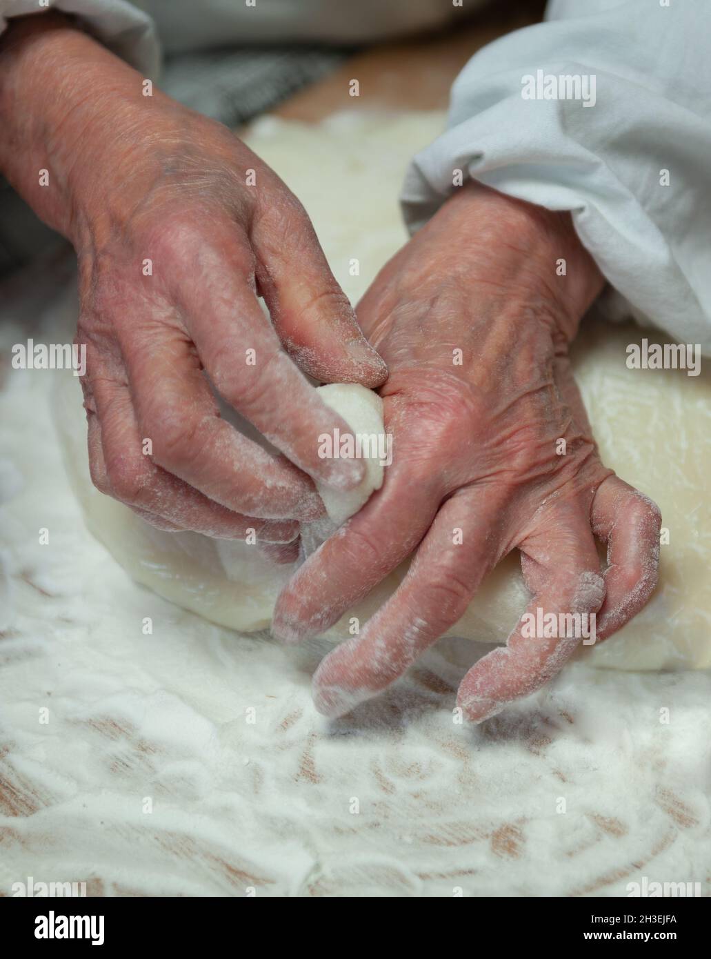 Closeup of elderly hands. Senior Asian woman making traditional ...