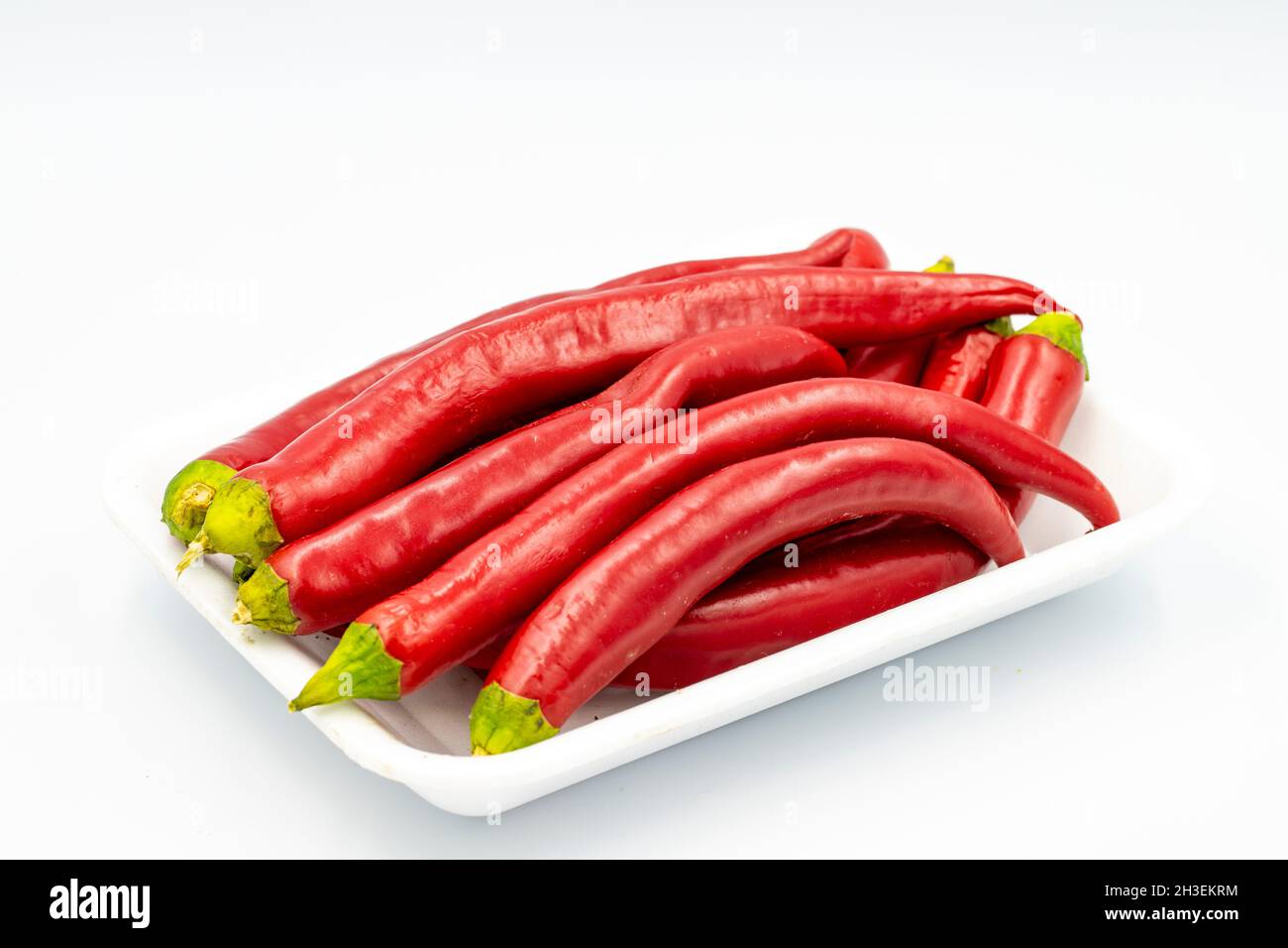 Packet red hot chili pepper on white background with shadow. close up ...