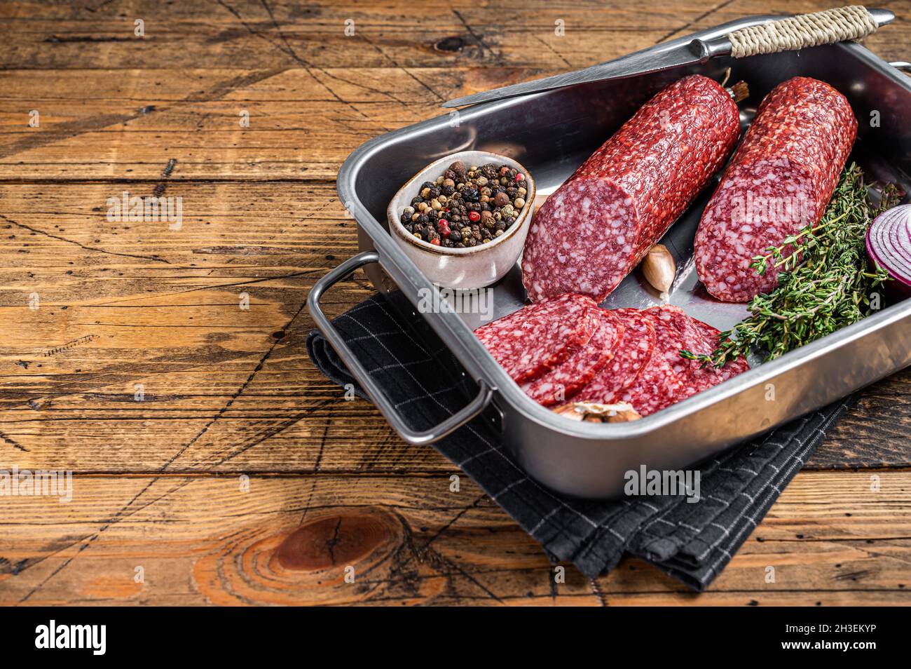 Italian Sliced Dry salami sausage in steel tray. Wooden background. Top ...