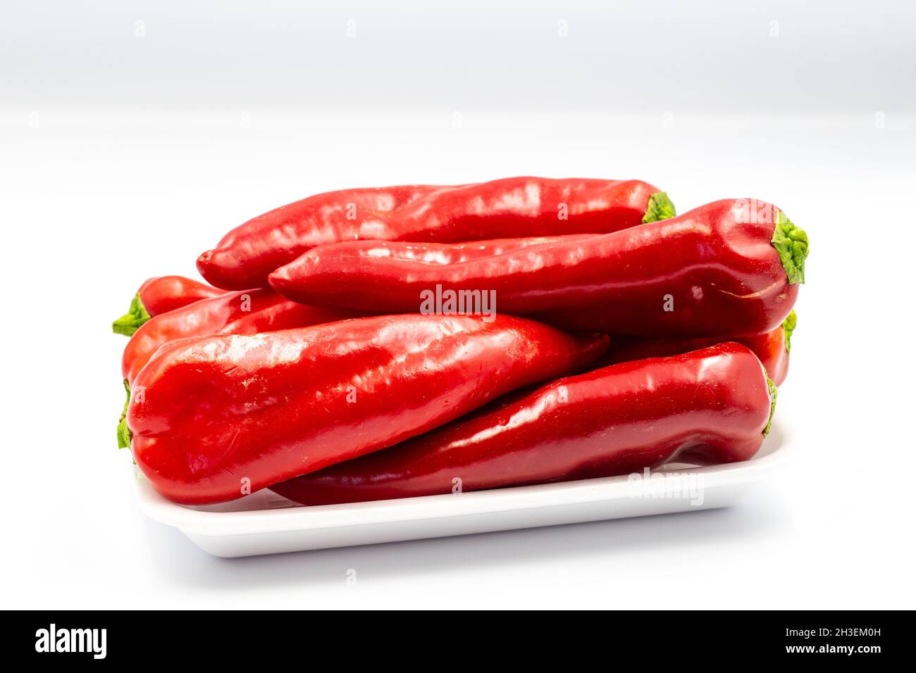 Packet red hot chili pepper on white background with shadow. close up ...