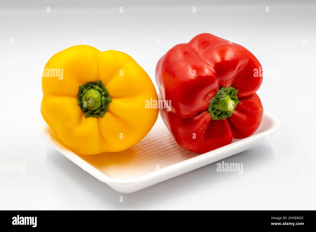 Packet yellow and red bell peppers on white background with shadow ...