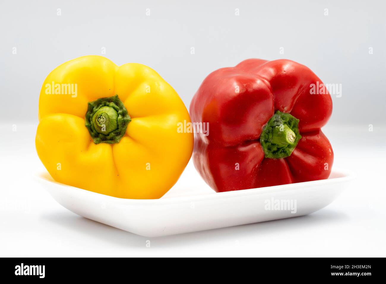 Packet yellow and red bell peppers on white background with shadow ...