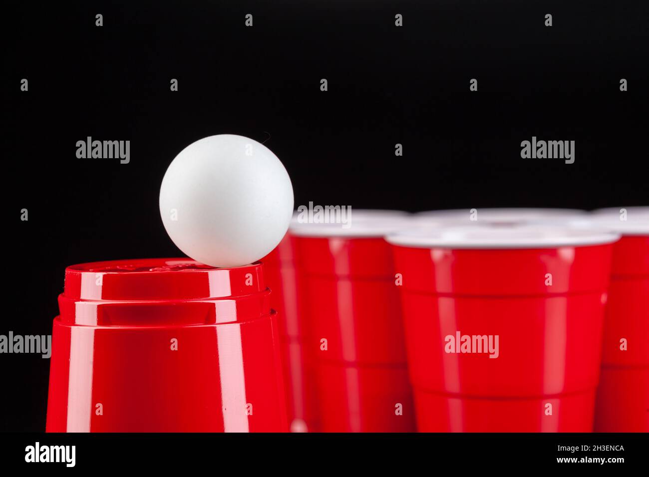 Red plastic cups and ball for game of beer pong Stock Photo - Alamy