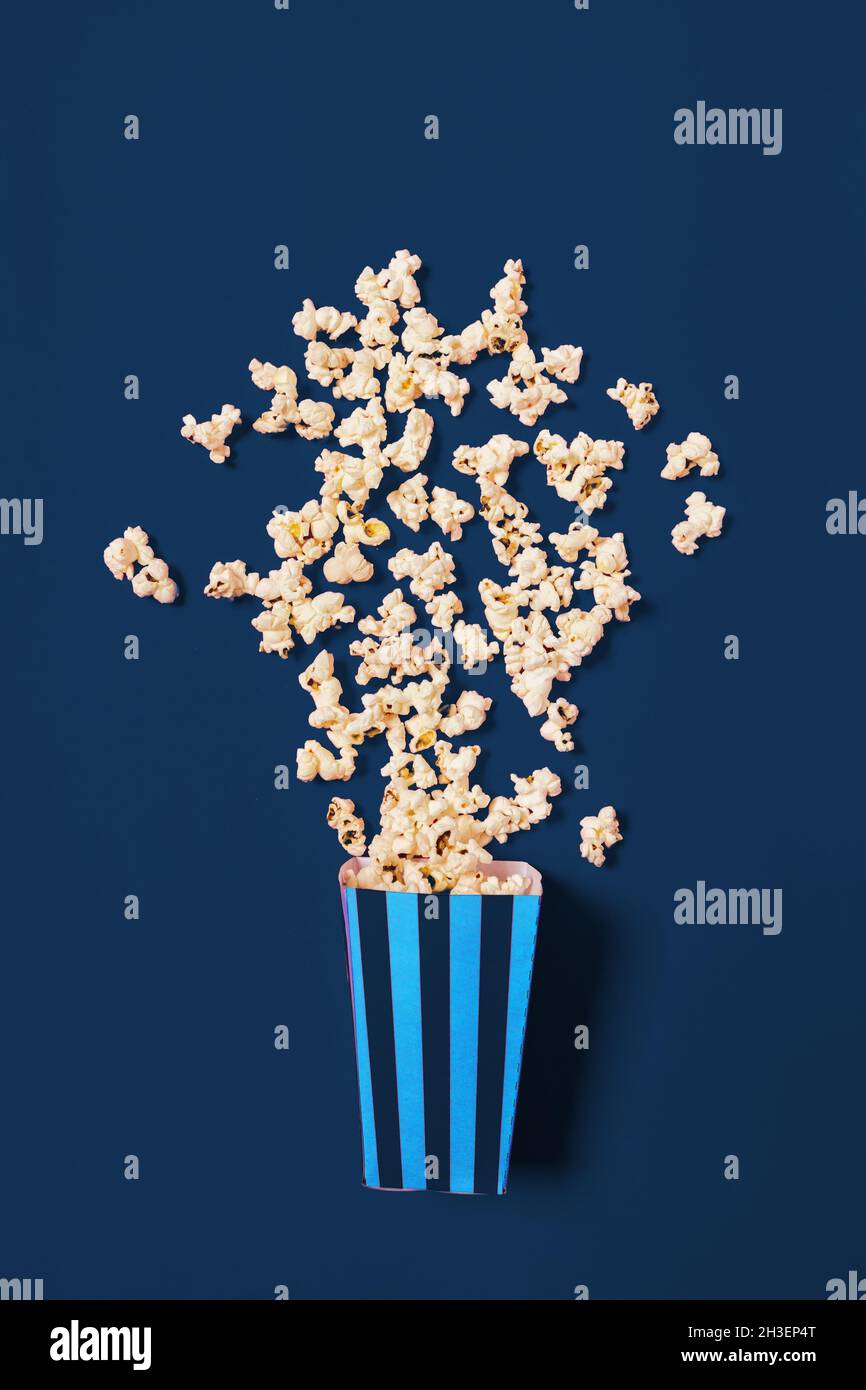 popcorn on classic blue color background top view Stock Photo - Alamy