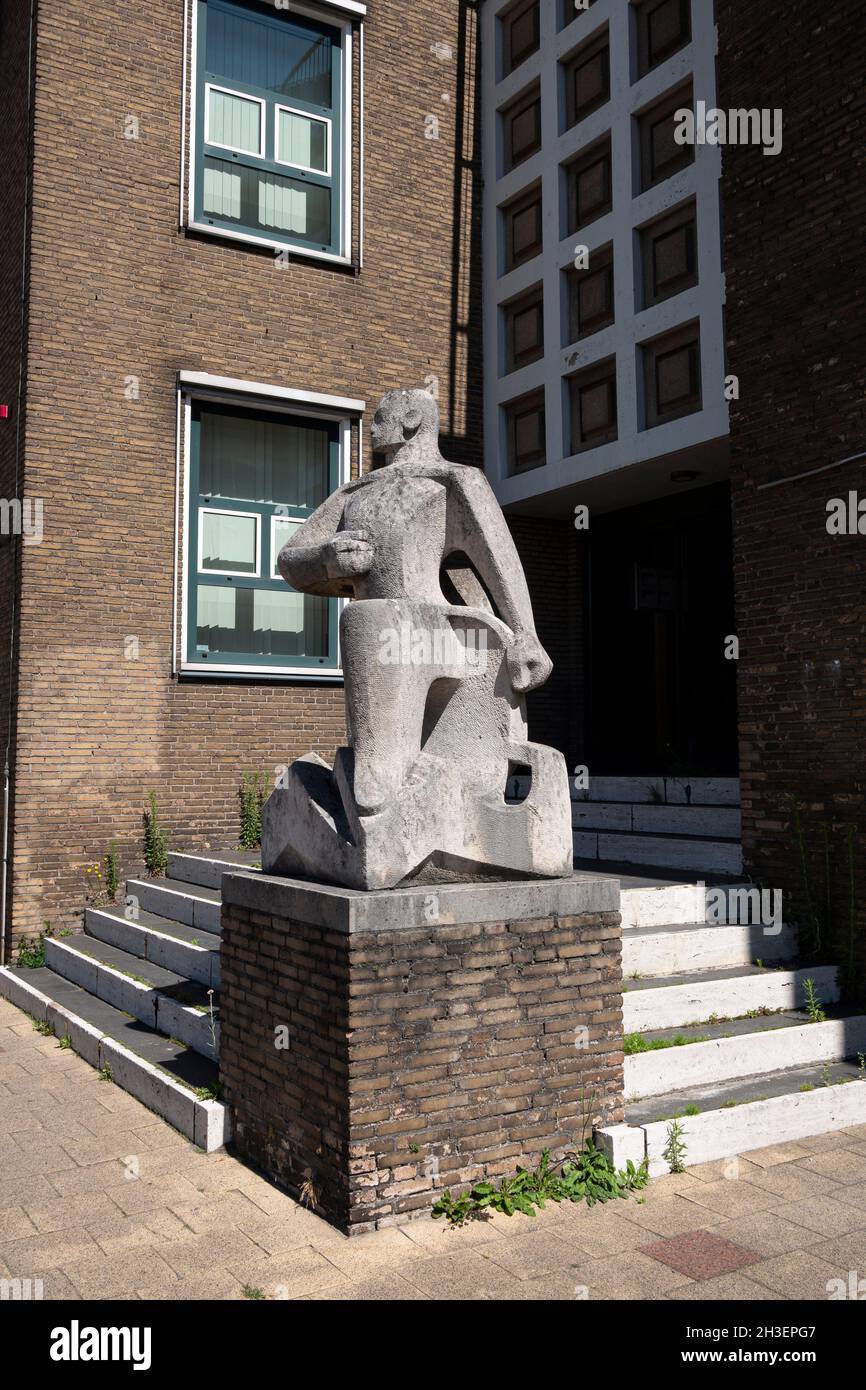 A free-standing modern statue of a kneeling but upright figure Stock ...