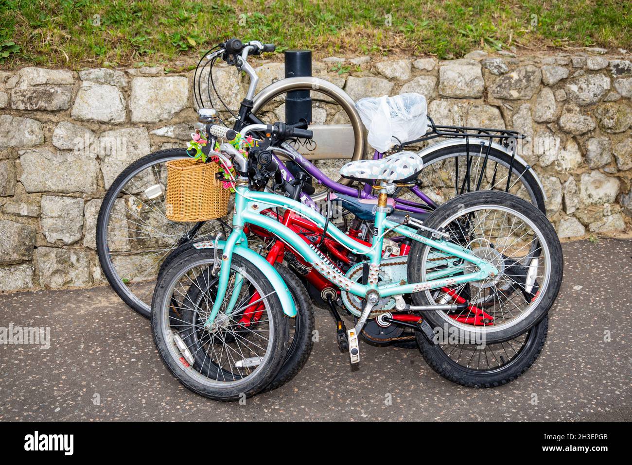 Family of bicycles. Adult and child bicycles chained together locked to ...