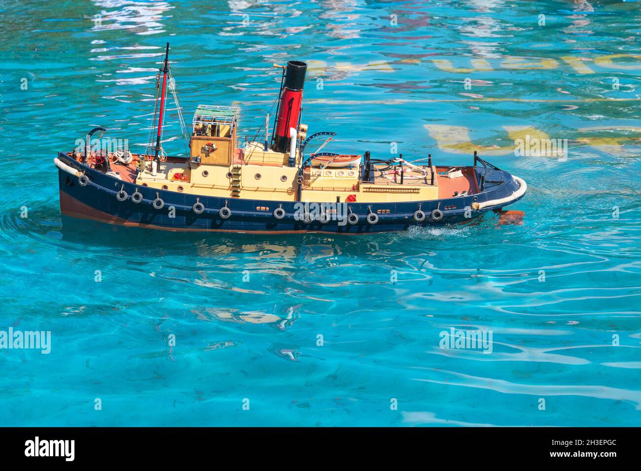 Miniature boat on the water, an old fishing boat Stock Photo - Alamy