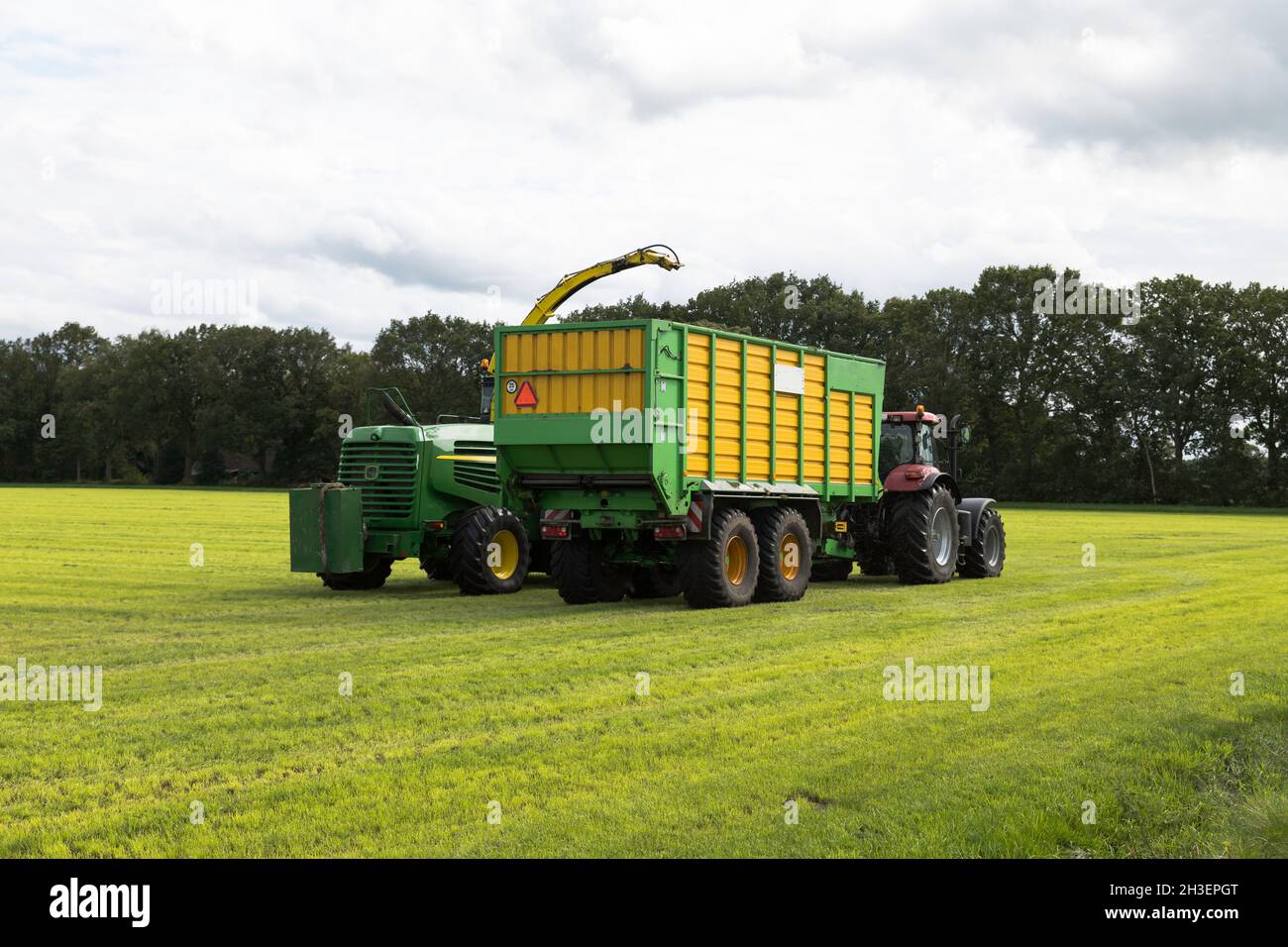 a farmer with tractor is harvesting grass Stock Photo - Alamy
