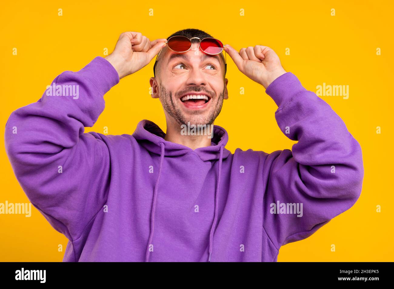 Portrait of attractive cheerful dreamy guy touching specs good mood ...