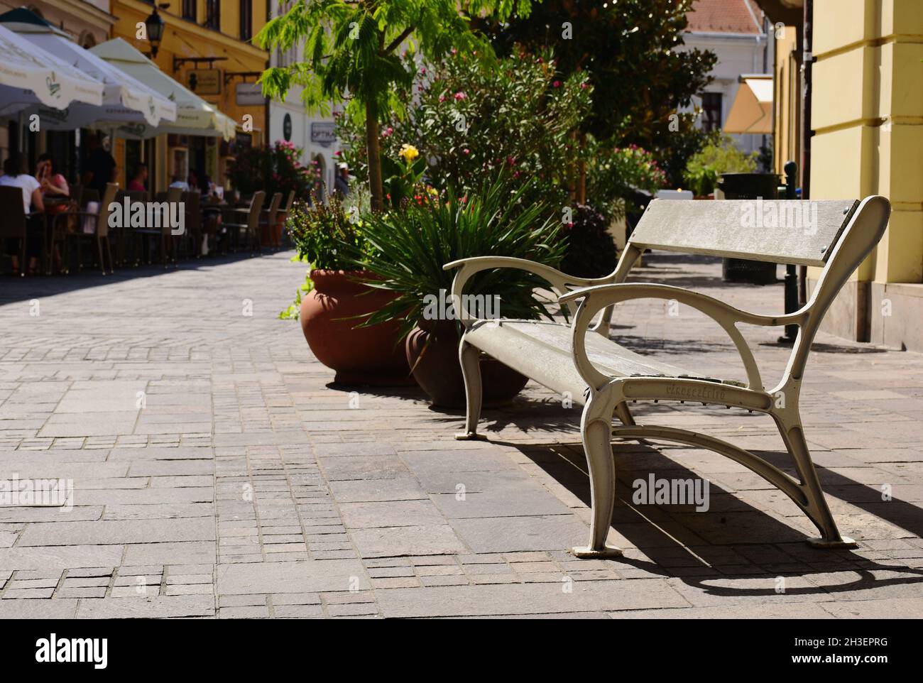 cast iron and wood street bench. patio cafe. old european streetscape ...