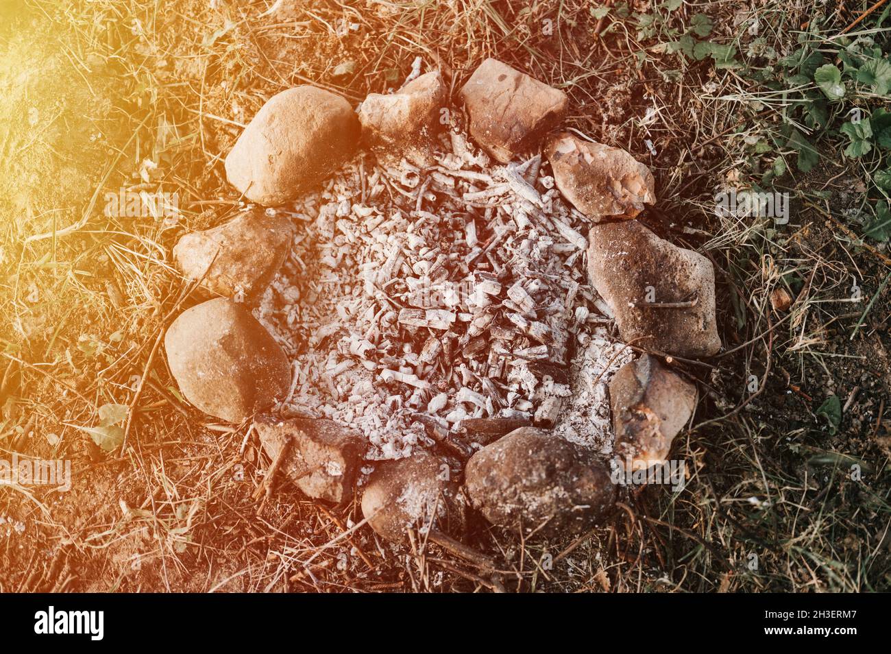 smoldering and ember gray coals and ashes from an extinct campfire in ...
