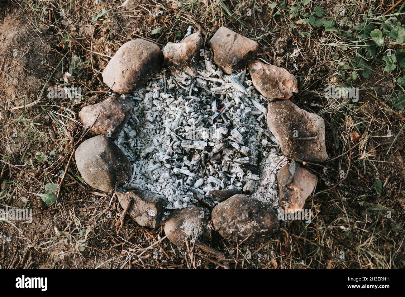 smoldering and ember gray coals and ashes from an extinct campfire in ...