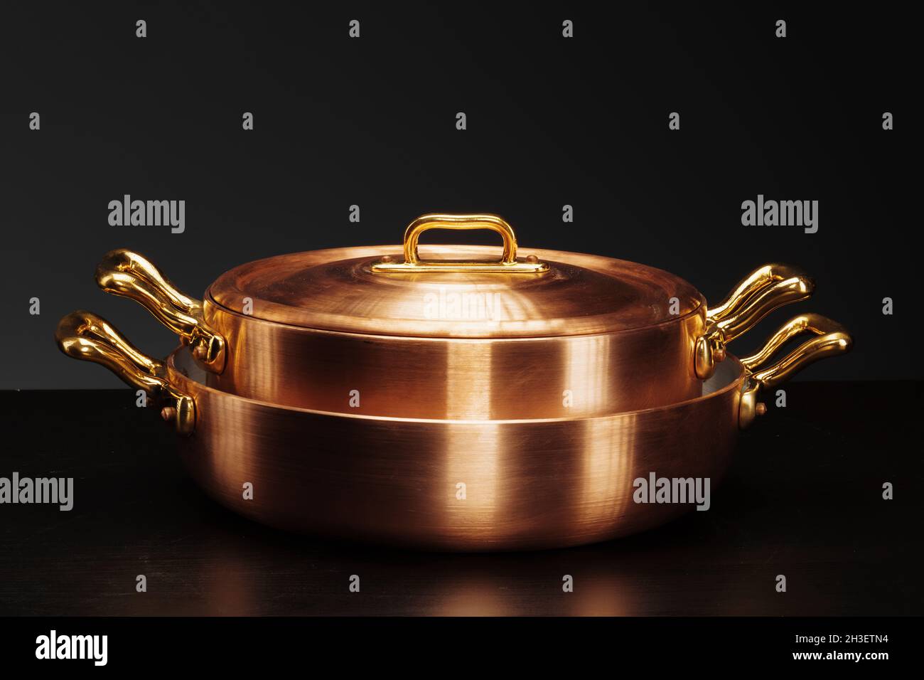Set of copper cookware over dark background Stock Photo - Alamy