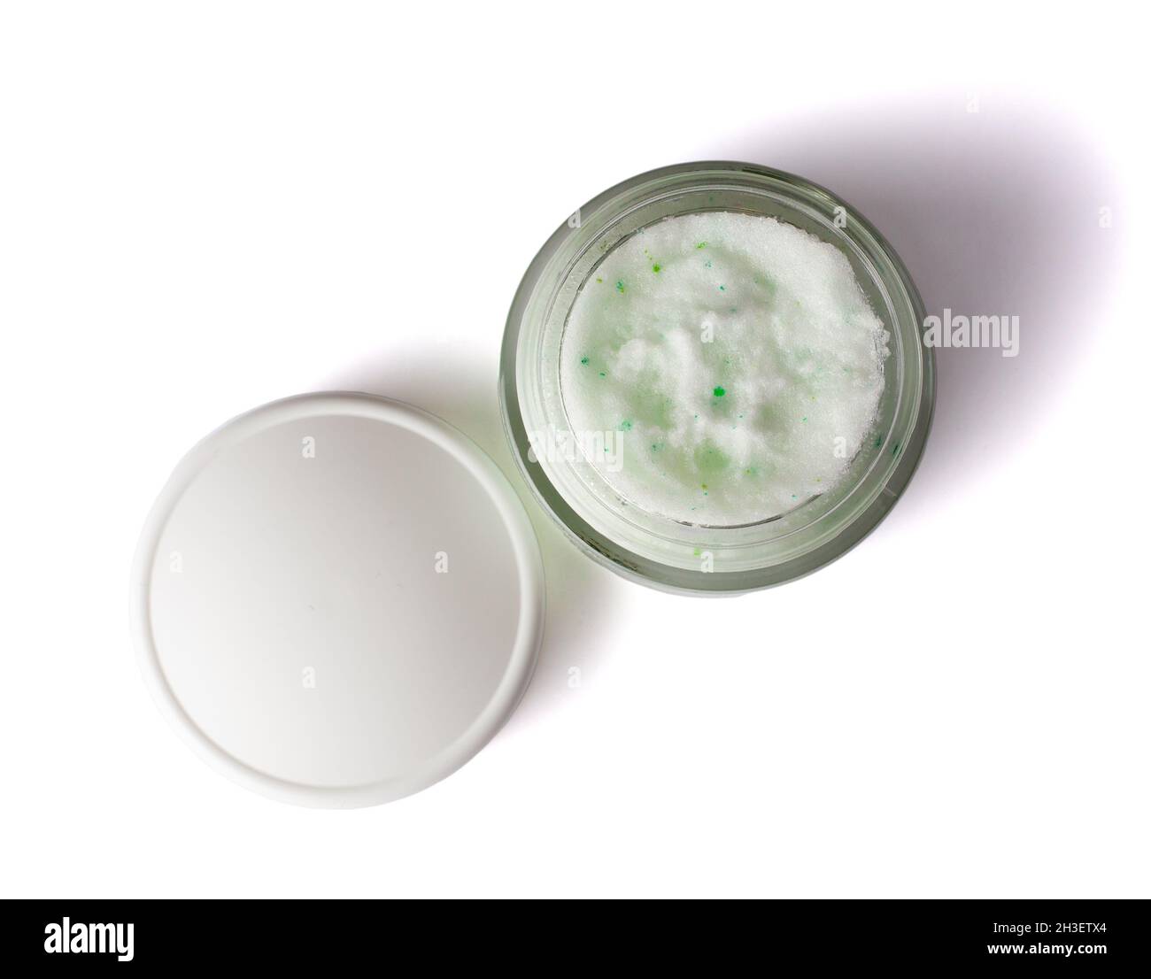 Texture cosmetic scrub for face and body in glass jar with white cap ...
