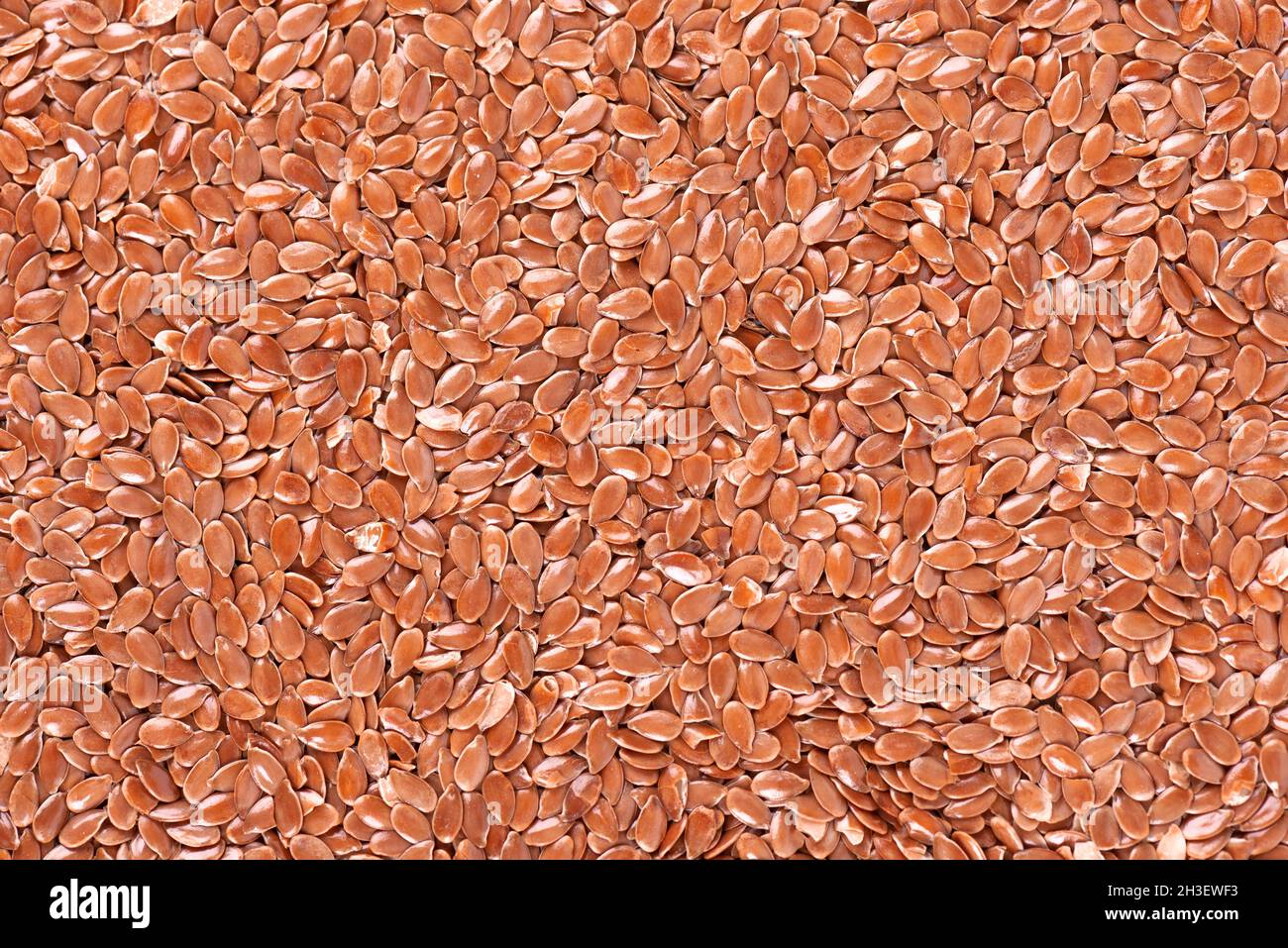 Brown flax seeds background. Heap of dry flaxseed or linseed. Top view ...