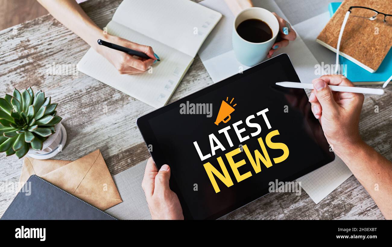 Latest news text and icon on device screen. Business internet and ...