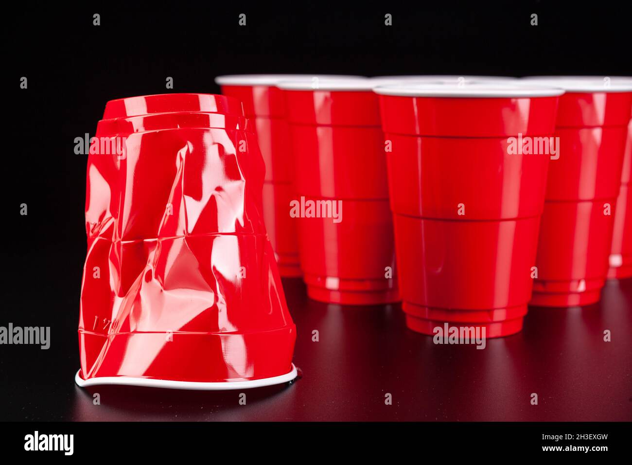 Red plastic cups and ball for game of beer pong Stock Photo - Alamy