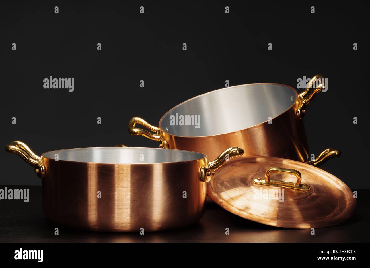 Set of copper cookware over dark background Stock Photo - Alamy