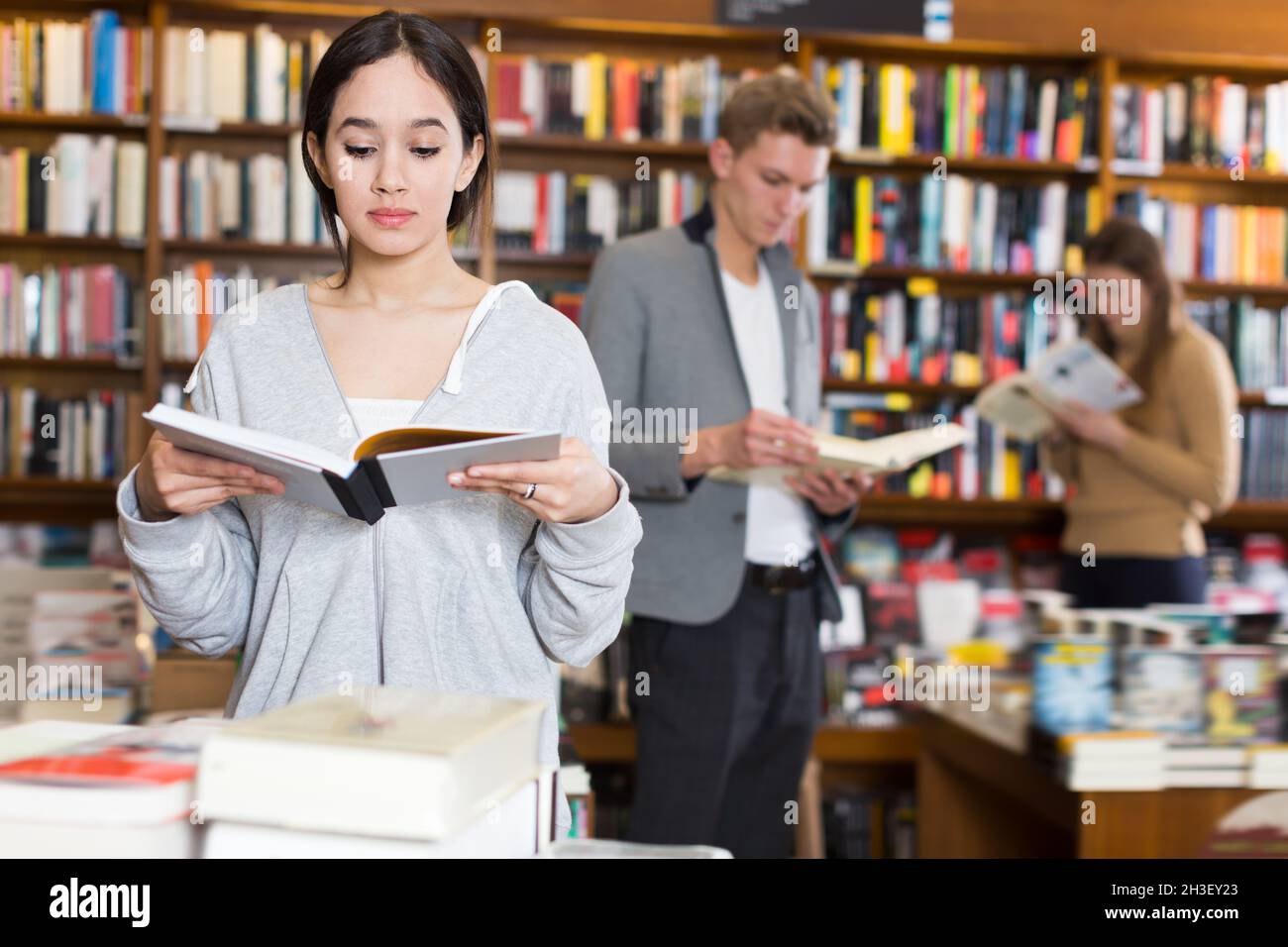 Attractive girl reading interesting book Stock Photo - Alamy