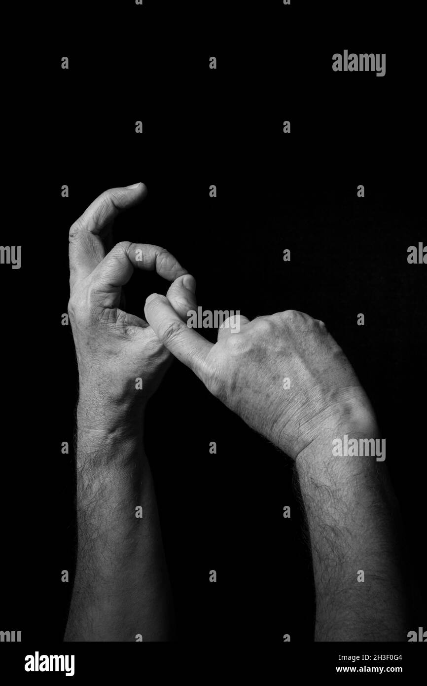 Dramatic B+W image of male hand fingerspelling BSL British sign ...