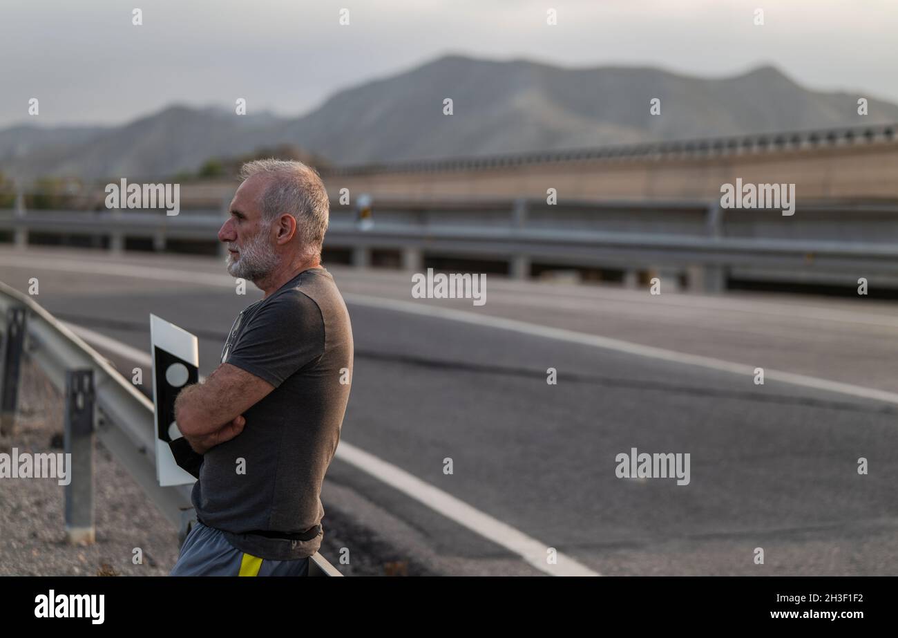 Man standing at roadside hi-res stock photography and images - Alamy