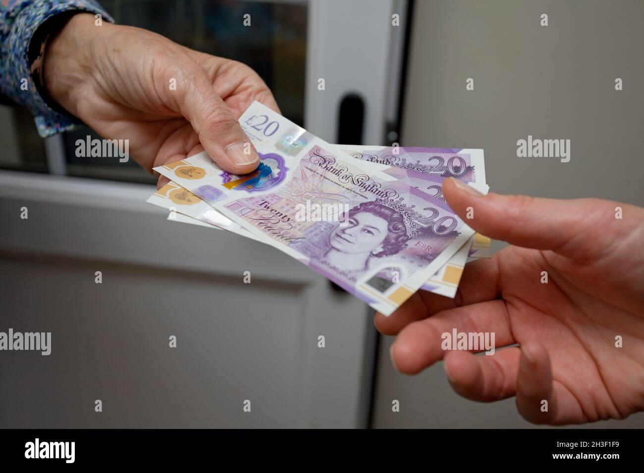 Paying in cash. uk Stock Photo - Alamy