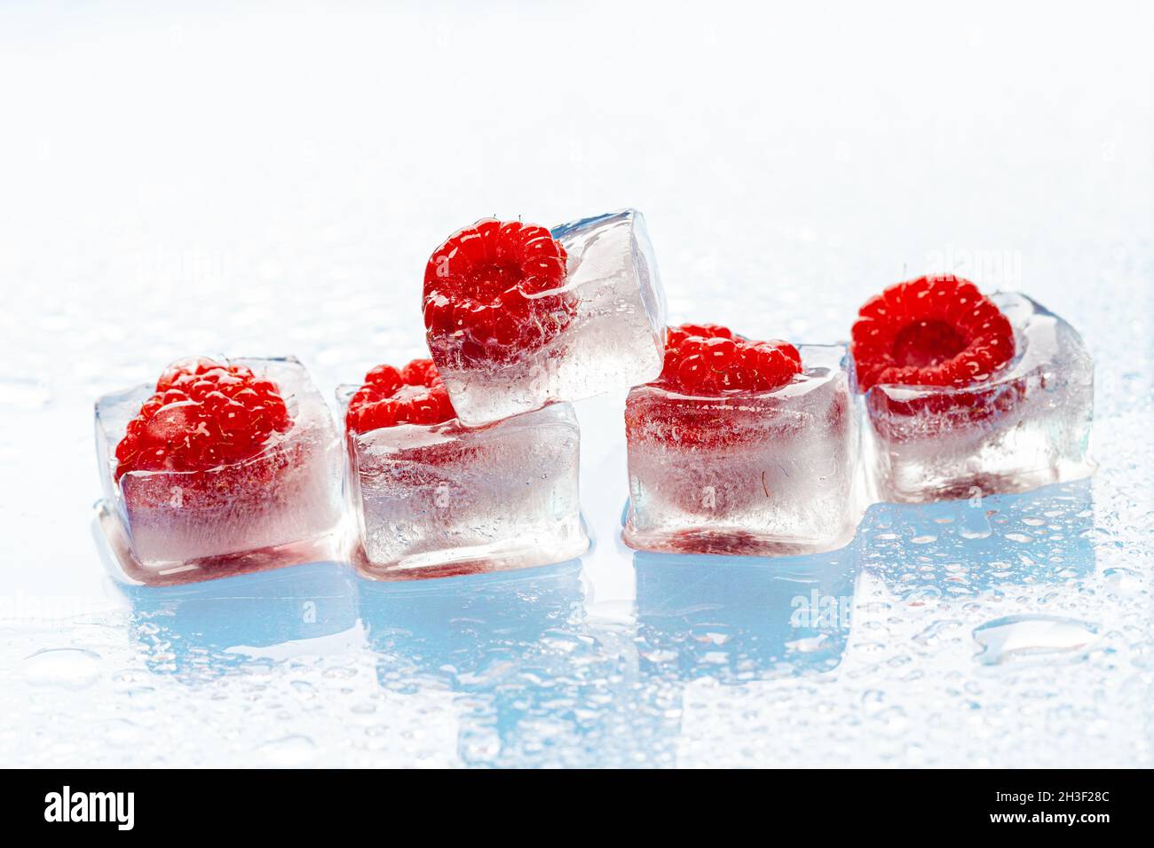 Ice cubes with frozen berries inside close up Stock Photo - Alamy