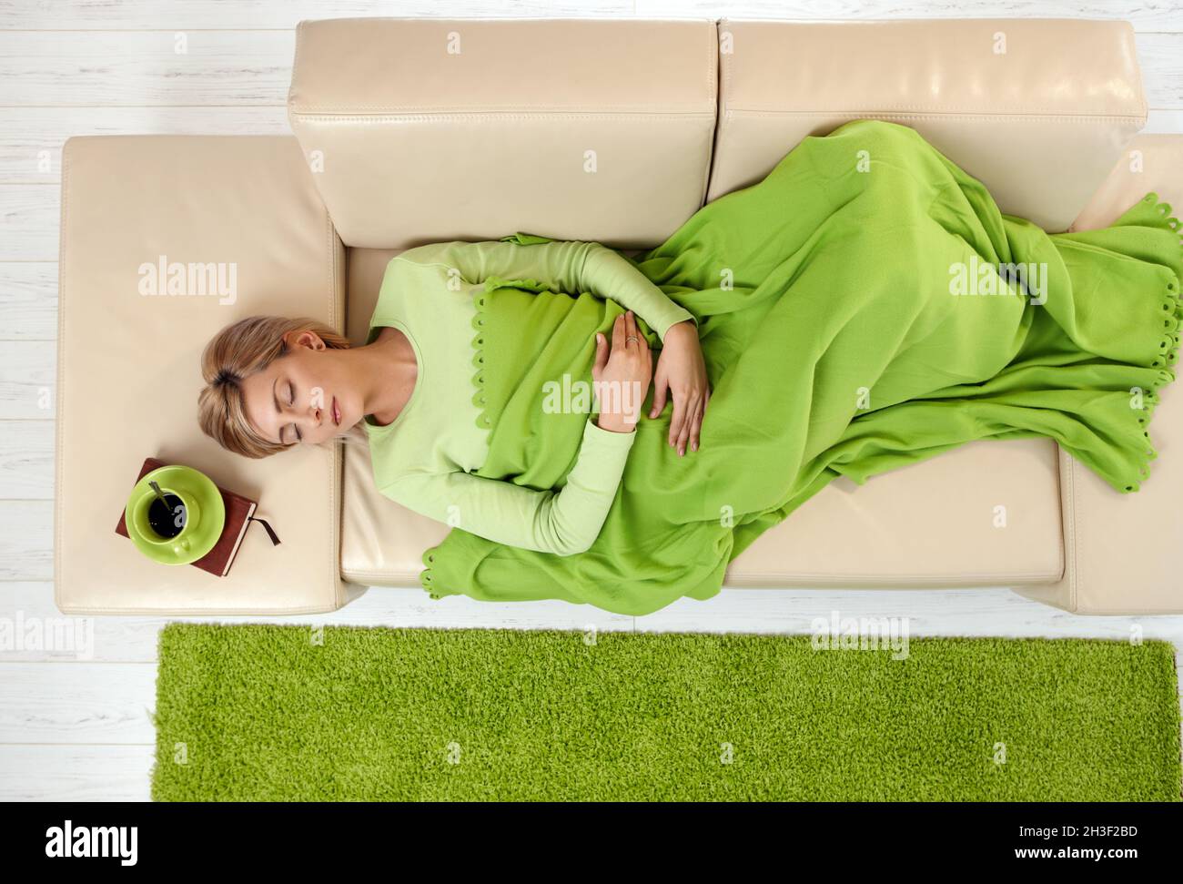 Woman sleeping under blanket Stock Photo - Alamy