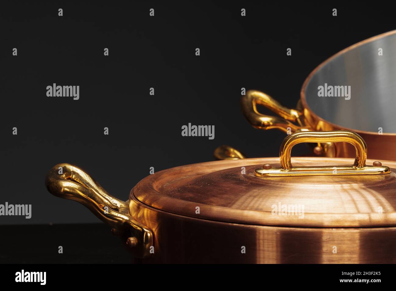 Set of copper cookware over dark background Stock Photo - Alamy
