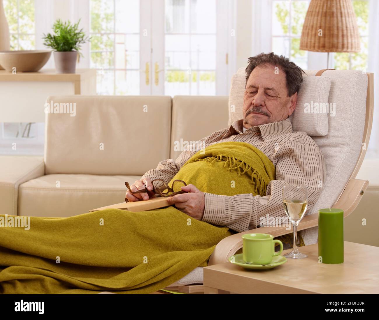 Old man sleeping in armchair hi-res stock photography and images - Alamy