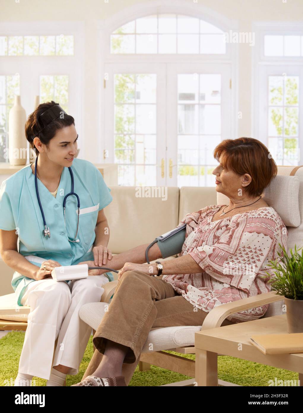 Nurse measuring blood pressure Stock Photo - Alamy