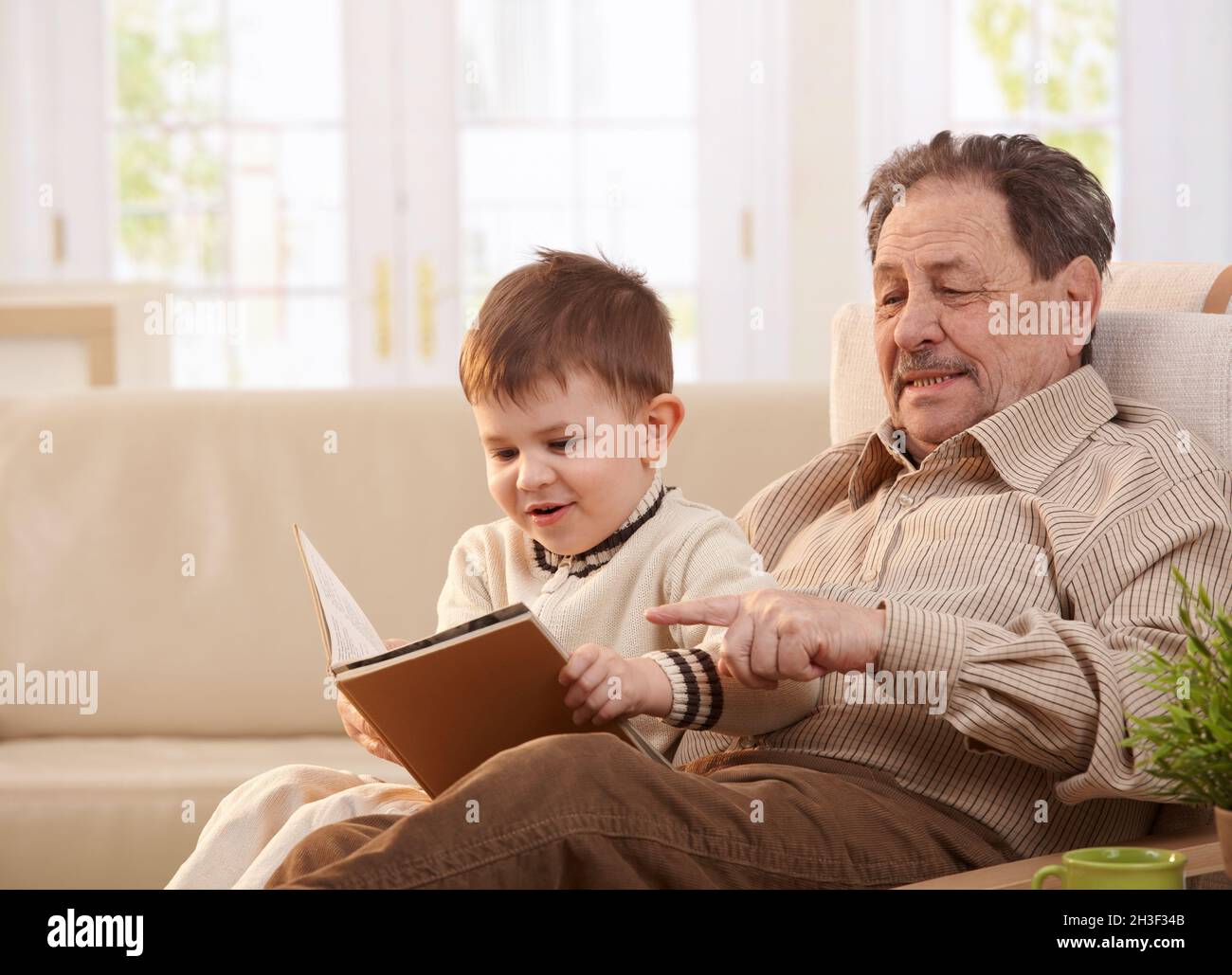 Grandfather and grandson together at home Stock Photo - Alamy