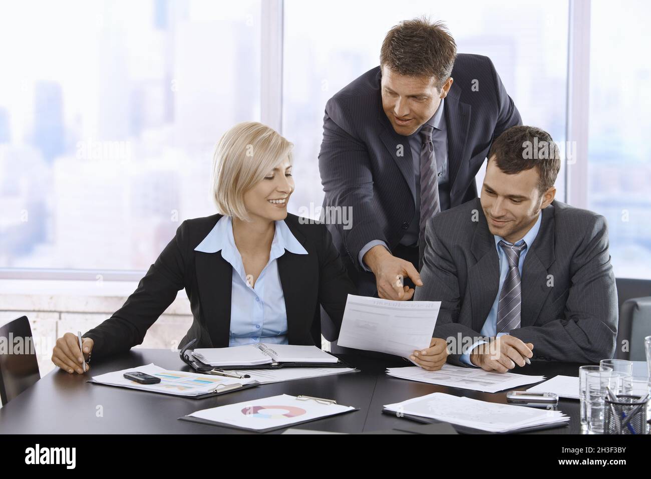 Male female coworkers reviewing documents hi-res stock photography and ...