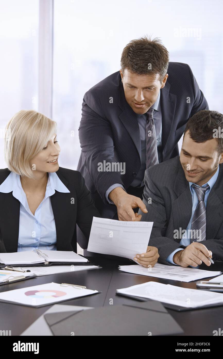 Group professionals reviewing documents hi-res stock photography and ...
