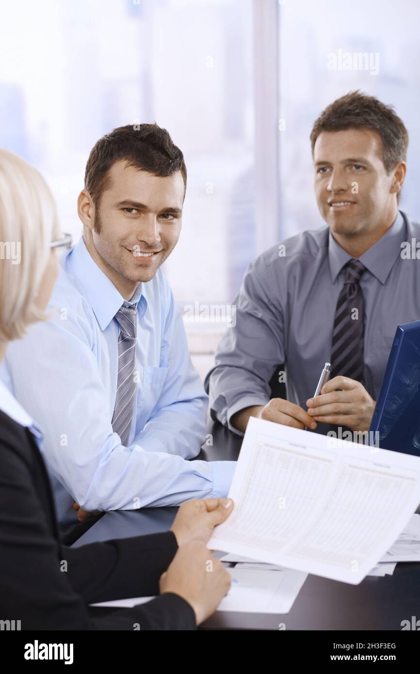 Business professionals working together reviewing hi-res stock ...