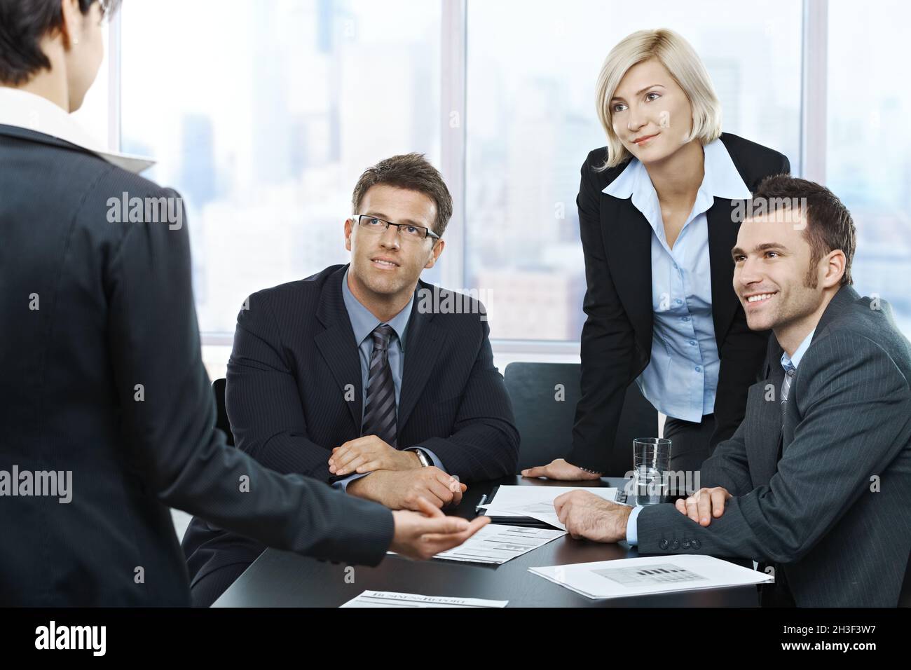 Businesswoman reporting to colleagues Stock Photo - Alamy