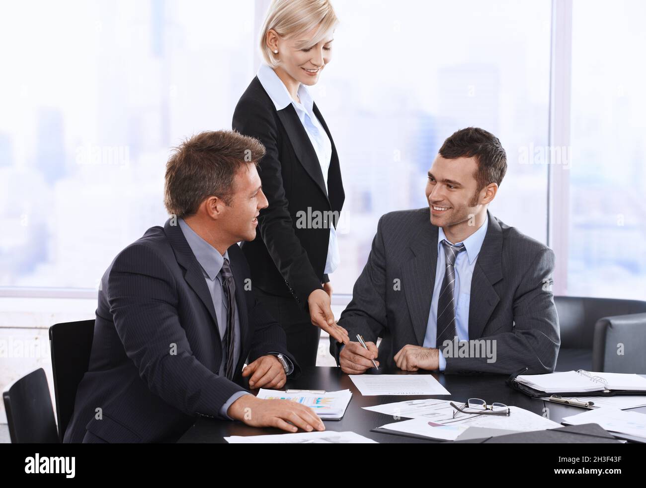 Business associates signing partnership contract hi-res stock ...