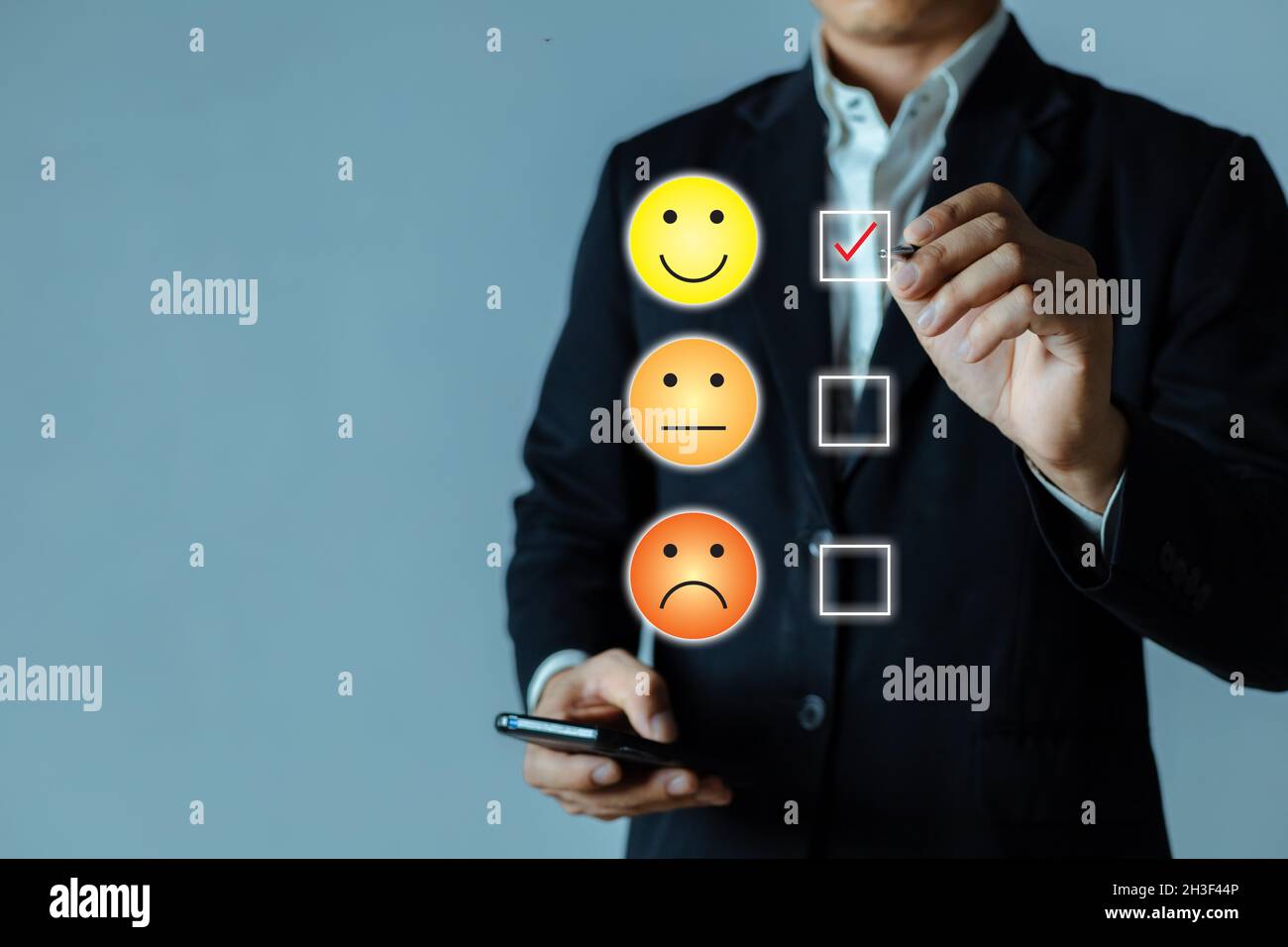 Businessman hand putting check mark a checkbox on excellent smiley face ...