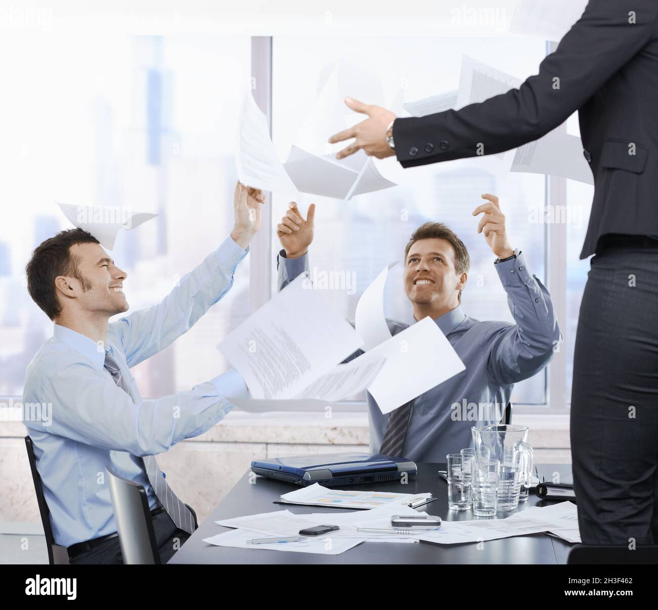 Businessmen throwing documents up Stock Photo - Alamy