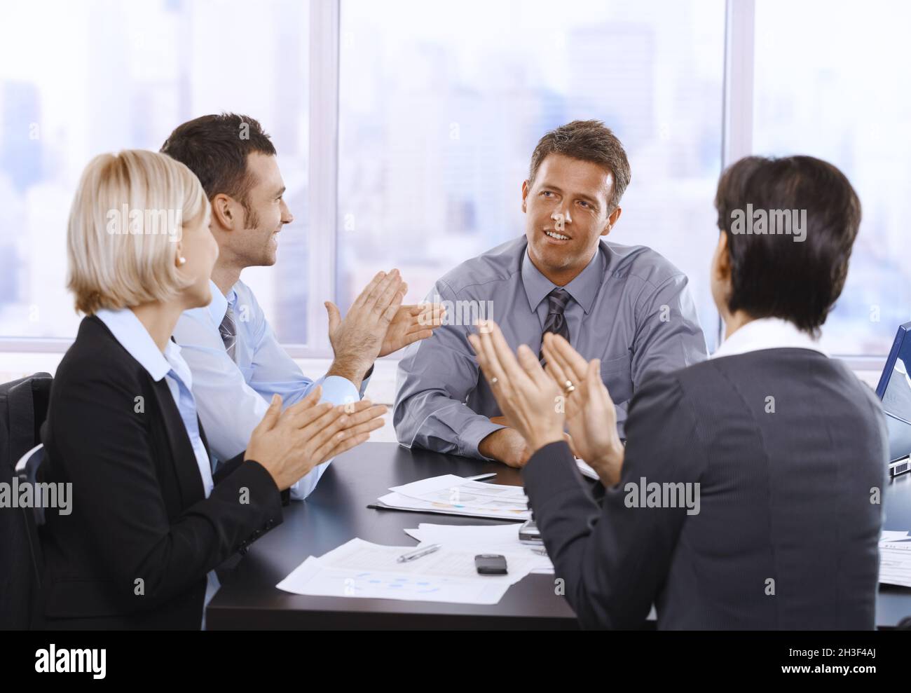 Businesspeople clapping hands Stock Photo - Alamy