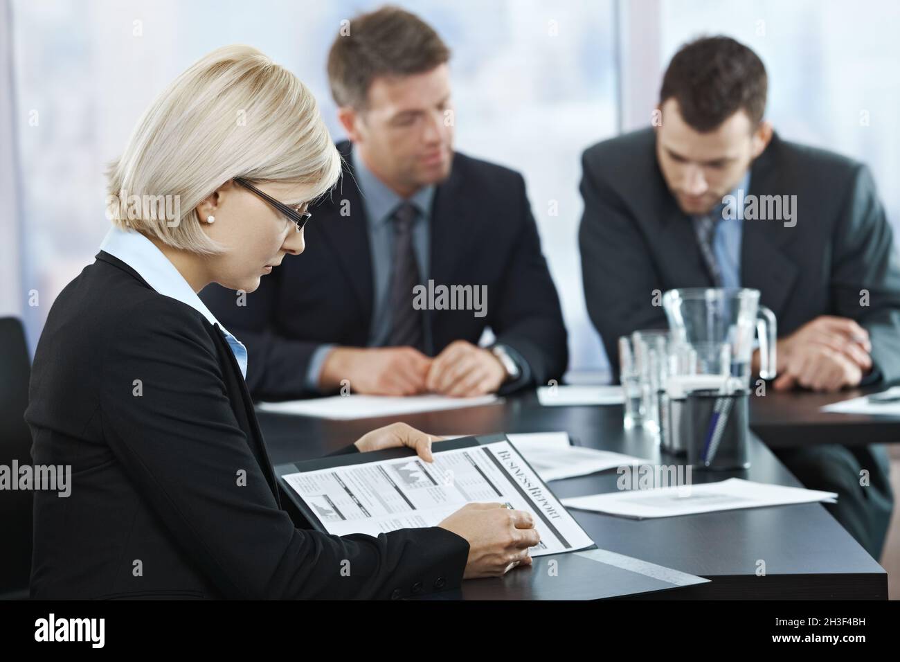 Professional checking documents at meeting Stock Photo - Alamy