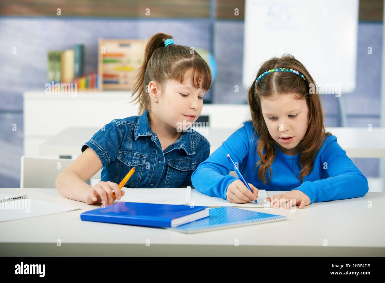 Children learning in classroom Stock Photo - Alamy