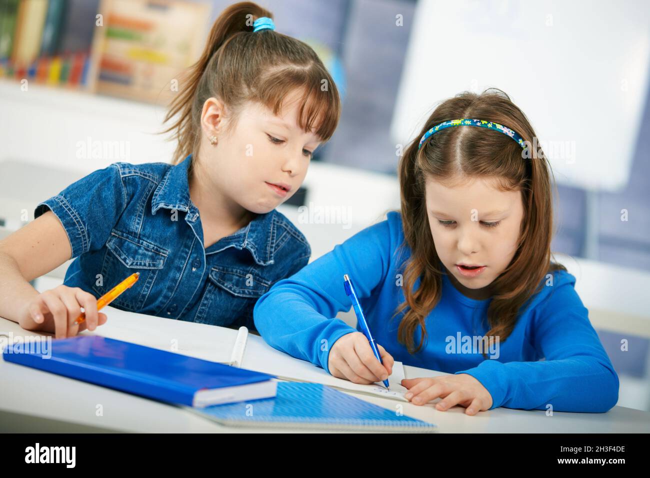 Schoolgirls learning in classroom Stock Photo - Alamy