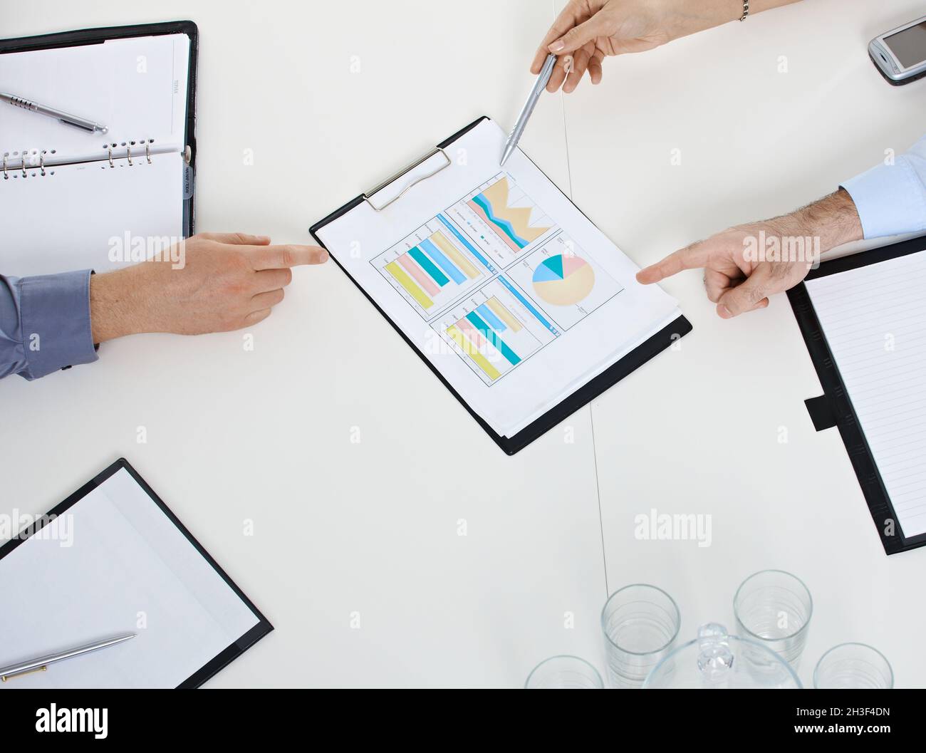 Hands over meeting business table Stock Photo - Alamy