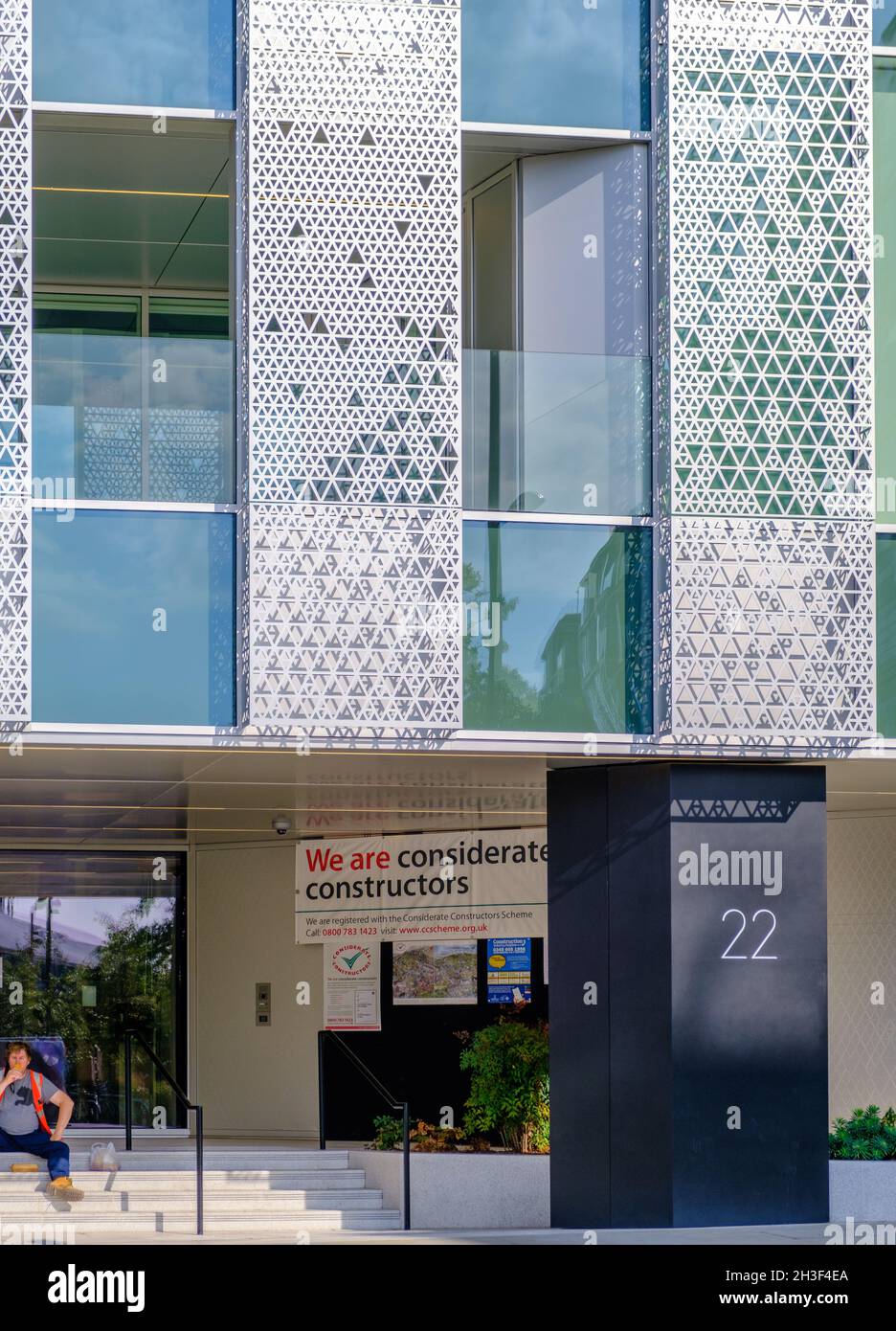 A workman takes a break sitting on the steps of 22 Handyside Street ...