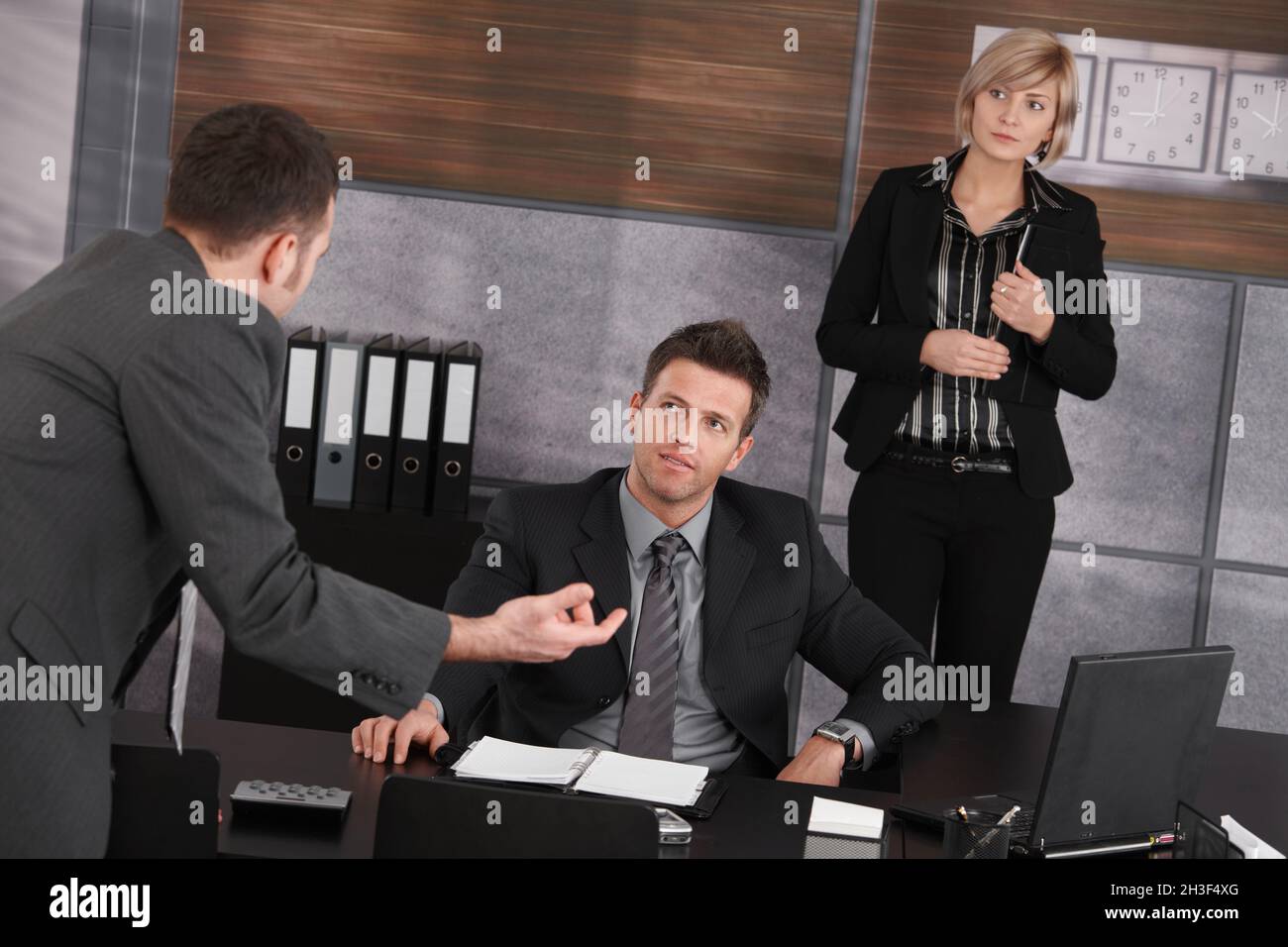 Manager listening to employee Stock Photo - Alamy