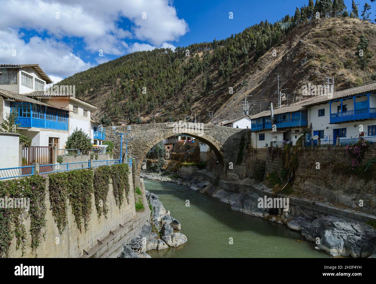 A stone bridge across a river in a small town. Cuzco, Peru Stock Photo ...