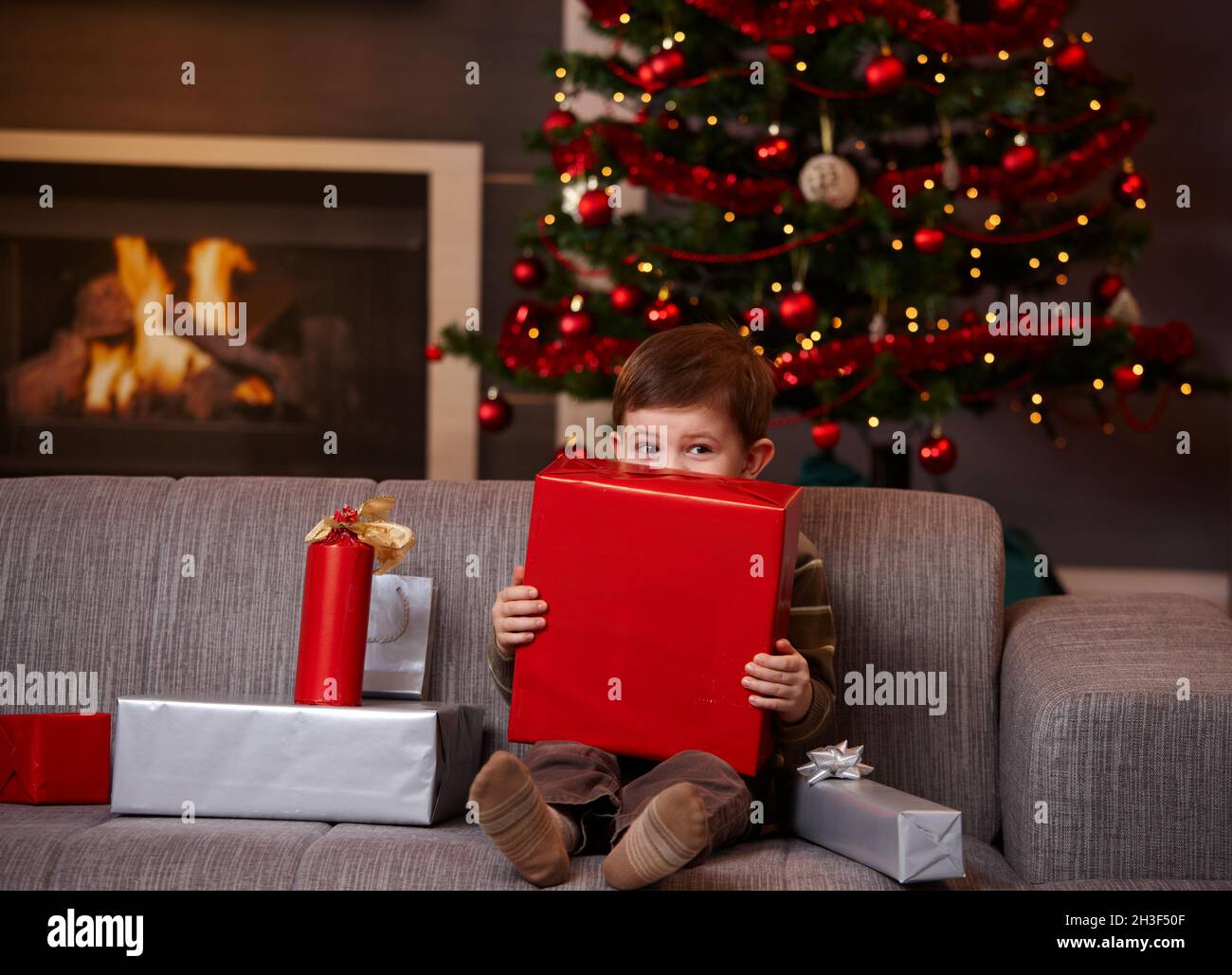 Boy hiding behind sofa hi-res stock photography and images - Alamy